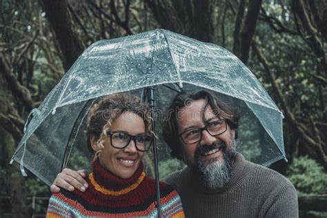 Relationship And Love Couple Under The Rain Smiling And Enjoying Outdoor Leisure Activity In