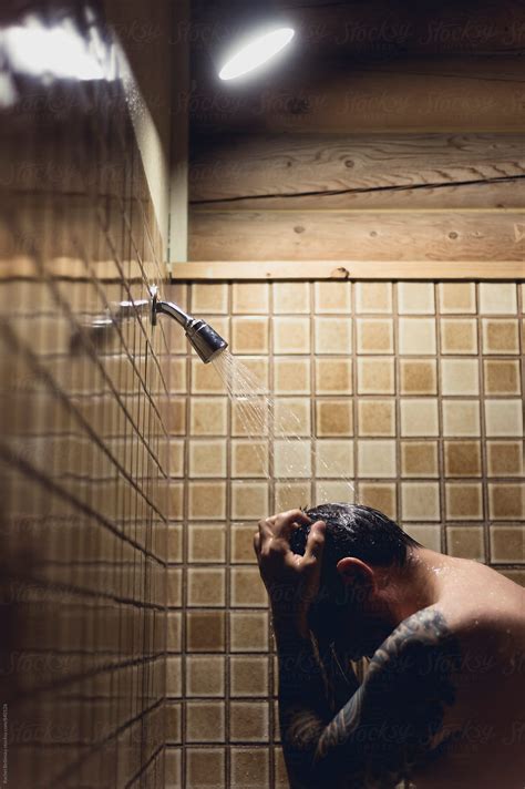 A Handsome Tattood Man Washes His Face In The Shower Del Colaborador