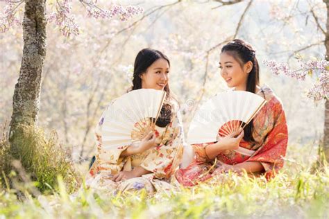 Two Japanese Girl Wearing A Kimono Holding A White Blow Beautiful