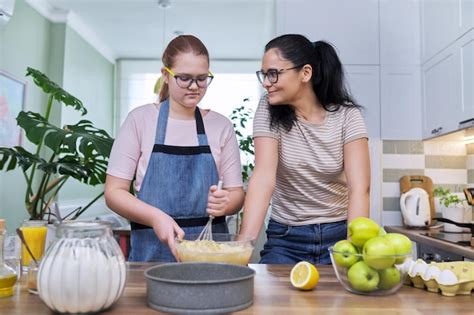 Premium Photo Mom And Teenage Daughter Preparing Apple Pie Together