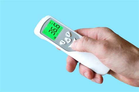 Premium Photo Hand Holding Contactless Thermometer Showing 366 Degrees By Celsius Temperature
