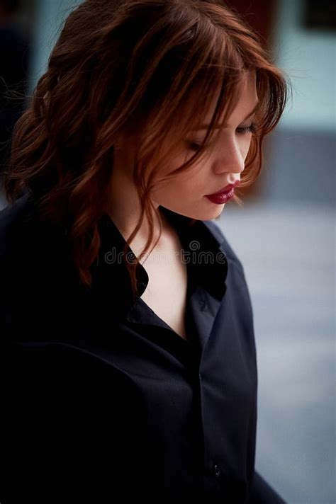 Portrait Of A Beautiful Redhead Fiery Hair And Full Lips Walking Around The City Stock Photo