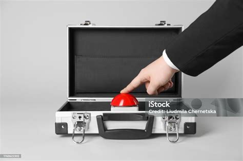 Man Pressing Red Button Of Nuclear Weapon On Light Gray Background Closeup War Concept Stock