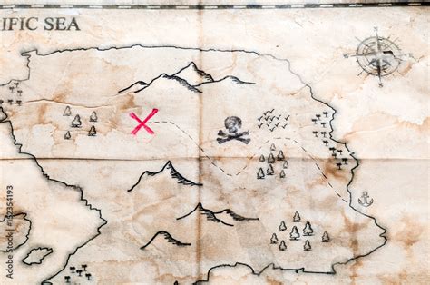 Close Up To Vintage Folded Fake Map With Red Cross Of Pirates Treasure