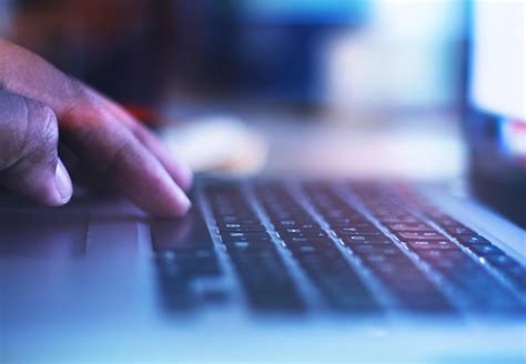 premium photo person typing on a keyboard