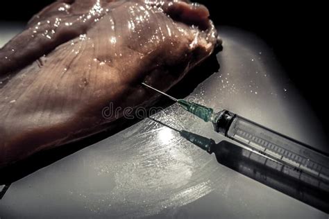 Piece Of Raw Meat Injected With Hormones Using Needle And Syringe Stock Photo Image Of Danger