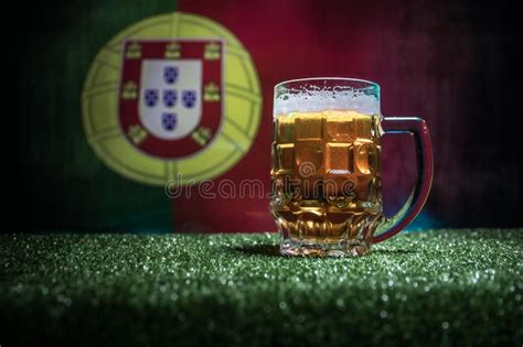 Creative Concept Pint Of Fresh Beer On Grass With Blurred Flag Of