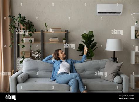 Smiling Woman Using Air Conditioner Remote Controller Switching Temperature Stock Photo Alamy