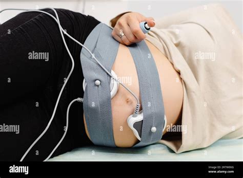 Woman Pregnant Checking Fetal Heart Beat By Fetal Monitoring Expectant Mother With Midwife