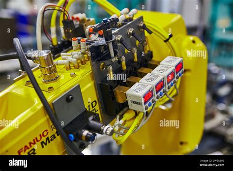 Precision Robotic Arm Control Detail In Industrial Setting Stock Photo