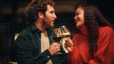 Couple Sitting Together At A Garden Party Celebration With Friends On A