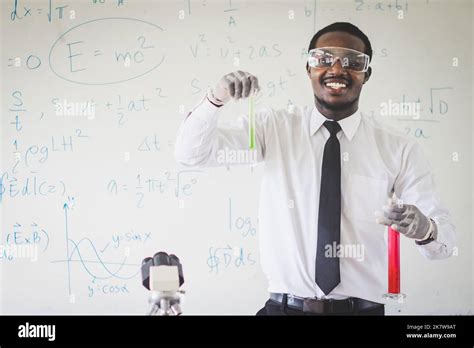 African Science Teacher Conducting Experiment Mixing Liquids In Flask Laboratory Assistant In
