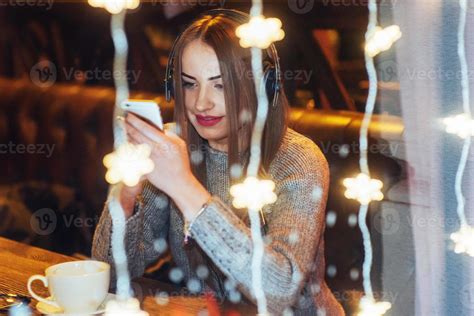 Young Beautiful Woman Sitting In Cafe Drinking Coffee Model Listening