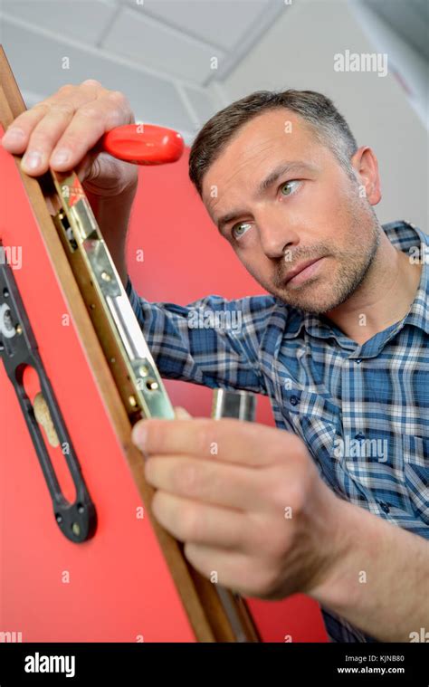 Man Fixing Door Lock Stock Photo Alamy