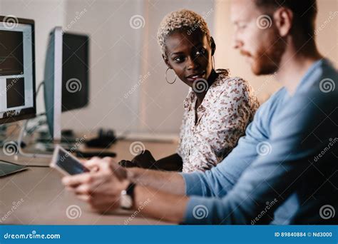 Programmers Cooperating At Information Technology Company Stock Photo
