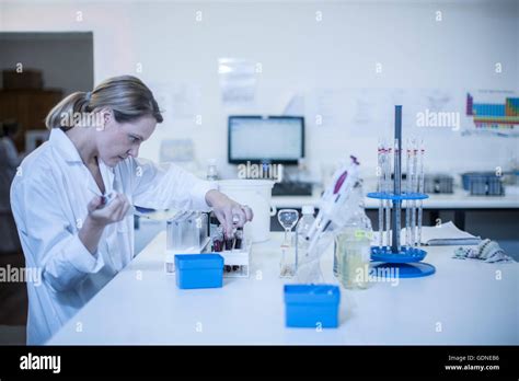 Mid Adult Woman Injecting Liquid Into Test Tube Stock Photo Alamy