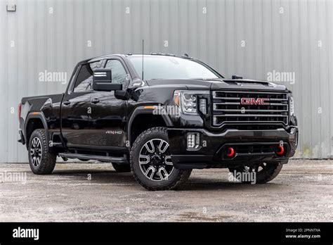 A Black Gmc Truck Parked On A Concrete Surface In A Natural Setting