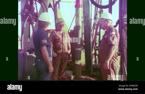1970s Three Workers Stand And Talk Around The Drill Pipe On Top Of The