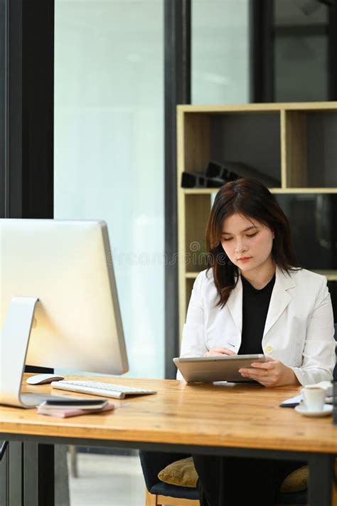 Professional Businesswoman Analyzing Sales Statistics Data On Her Digital Tablet Stock Image
