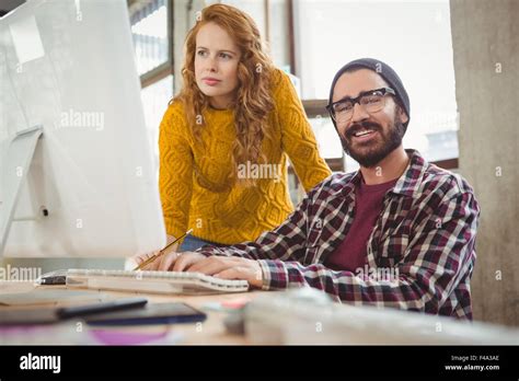 Man Smiling While Woman Looking At Computer Stock Photo Alamy