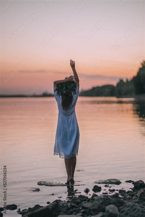 Sensual Girl In A White Long Vintage Dress Poses On The River Stones