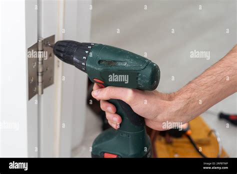 Screwing Hinge Installation On A Process Of Wood Door Stock Photo Alamy