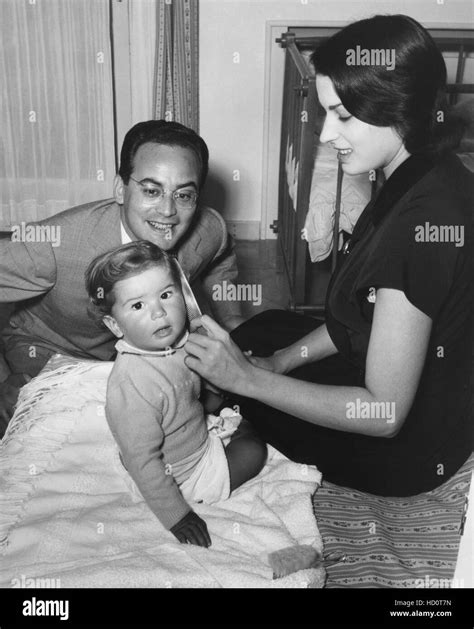 From Left Dino De Laurentiis Silvana Mangano At Home With One Of