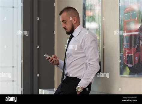 Business Man Reading Text Message On A Mobile In A Modern Office Stock Photo Alamy