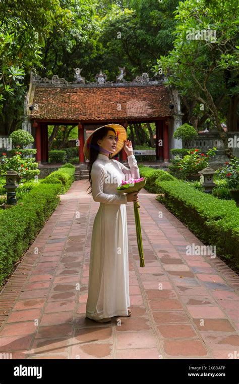 Pretty Vietnamese Young Woman Wearing Traditional Ao Dai Tunic Holding