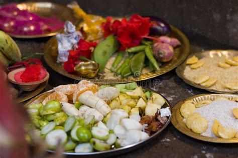 Various Fruits Vegetables And Sweets Are Kept Together In Brass Plates For Performing Puja