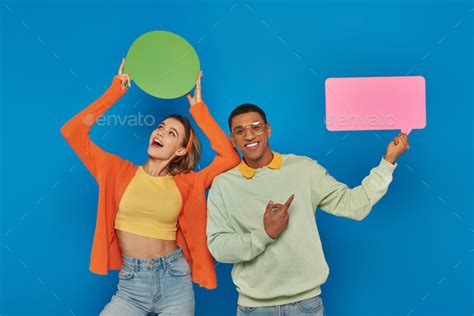 Happy Interracial Couple In Smart Casual Clothes Holding Blank Speech