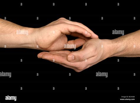 Male Hands Enclosing And Encompassing And Cupping Against Black Stock