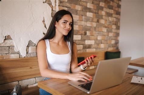 Premium Photo Attractive Girl Working On Laptop In Cafe Beautiful