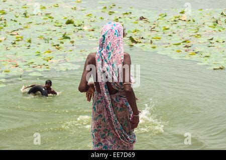 Indian Mother Bathing His Son On The Waters Of Tungabhadra River Hampi