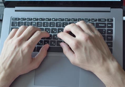 premium photo hands of a programmer working on a laptop