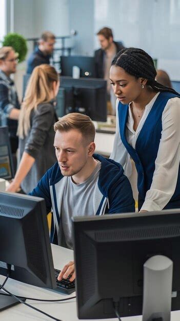 Caucasian Male Game Designer Using Desktop Computer With 3d Modelling Software And Talking To