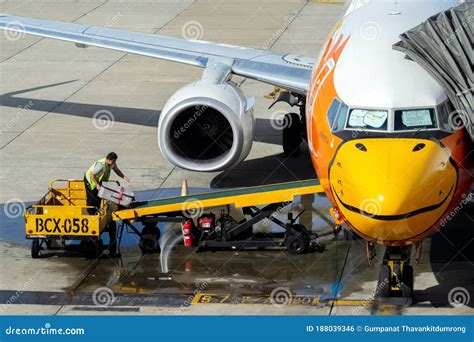 Loading A Passenger Plane On The Airport Tarmac With The Passengers