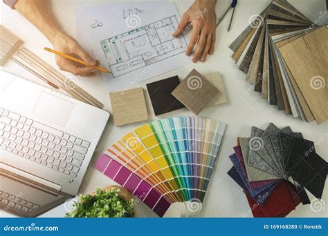 Designer Working In Office Doing Furniture And Flooring Material