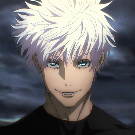 A Man With White Hair And Blue Eyes Looks At The Camera While Standing