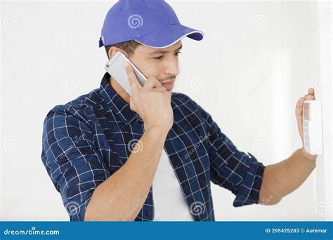 Man Installing Electrical Device On Wall Stock Image Image Of