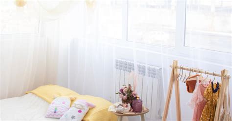 기하학적 러그 깔끔한 공간 꽃병 노란색 액센트 놀이방 드레이프 커튼 목재 가구 미니멀리스트 바닥 매트리스 밝은 분위기 밝은 인테리어 부드러운 섬유