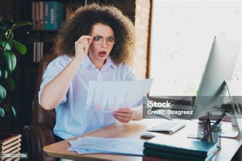 매력적인 곱슬 머리 젊은 여자 놀란 모습 그래프 착용 Formalwear 현대 사무실 비즈니스 컨설턴트 룸 인테리어 실내 작업 공간 실내 작업 공간의 사진 25 29세에