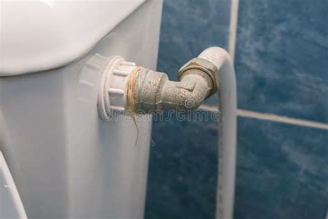 Connection Of Water To A Toilet Tank With A Pipe And Metal Corner Fitting Close Up Stock Image
