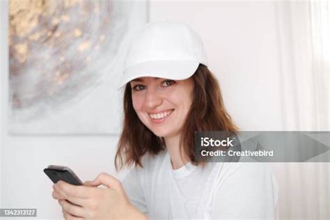 흰색 야구 모자를 쓰고 있는 여성 모델 흰색 캡 모형 사진 텍스트 또는 로고를위한 템플릿 모자의 바이저를 들고 소녀 여유 공간 복사 공간 야구 모자에 대한 스톡 사진 및