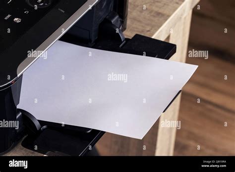 A Close Up Portrait Of A Printer With An Empty White Piece Of Paper In
