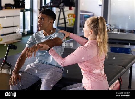 At Rehabilitation Center Diverse Physical Therapists Helping Biracial