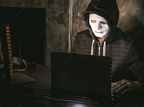 Man In Hoodie And Mask Stealing Data From Laptop As A Computer Hacker Photo Background And