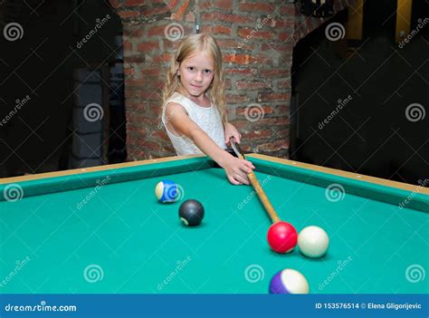 Little Beautiful Blond Girl Learns To Play Billiards Pool Snooker