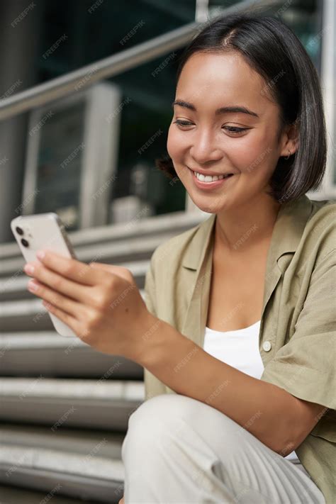 Free Photo Portrait Of Asian Girl Takes Selfie On Mobile Phone Korean