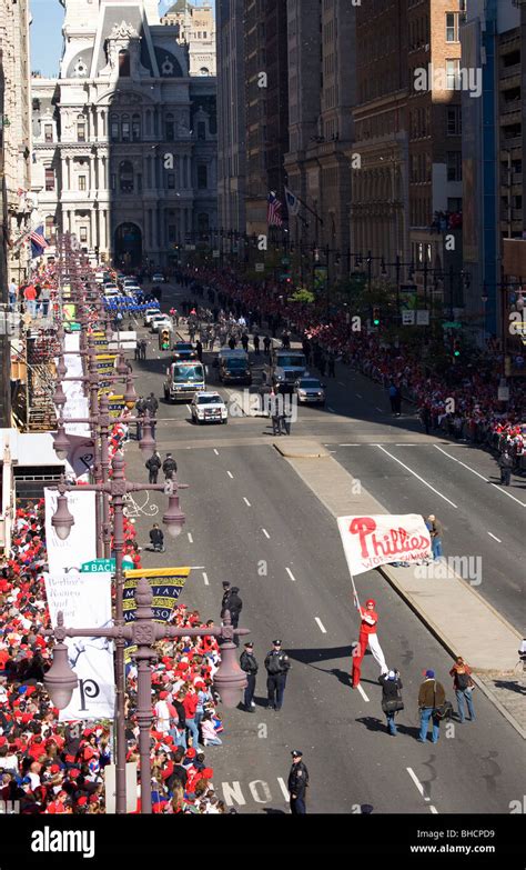 Man On Stilts Hoists Giant Philadelphia Phillies Banner And Flag While